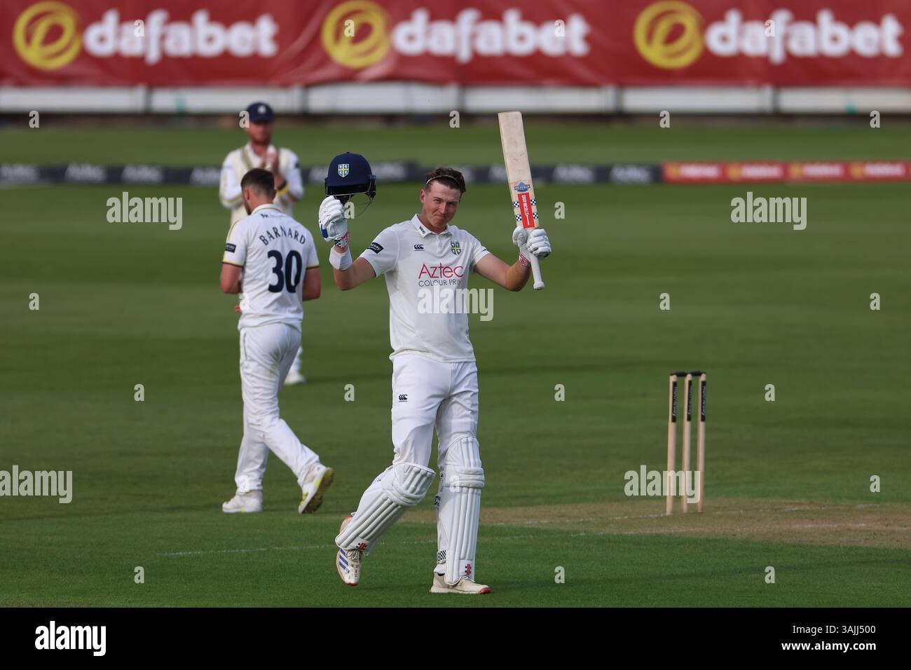 Durham's Ben McKinney celebrates after completing his century during ...