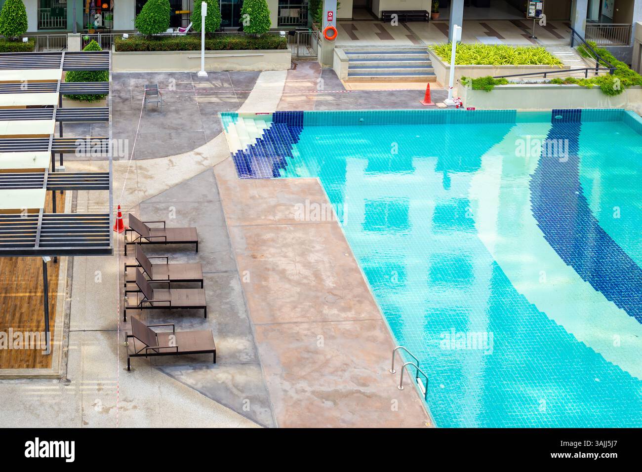 outdoor swimming pool surrounded by modern urban landscape with steps ...