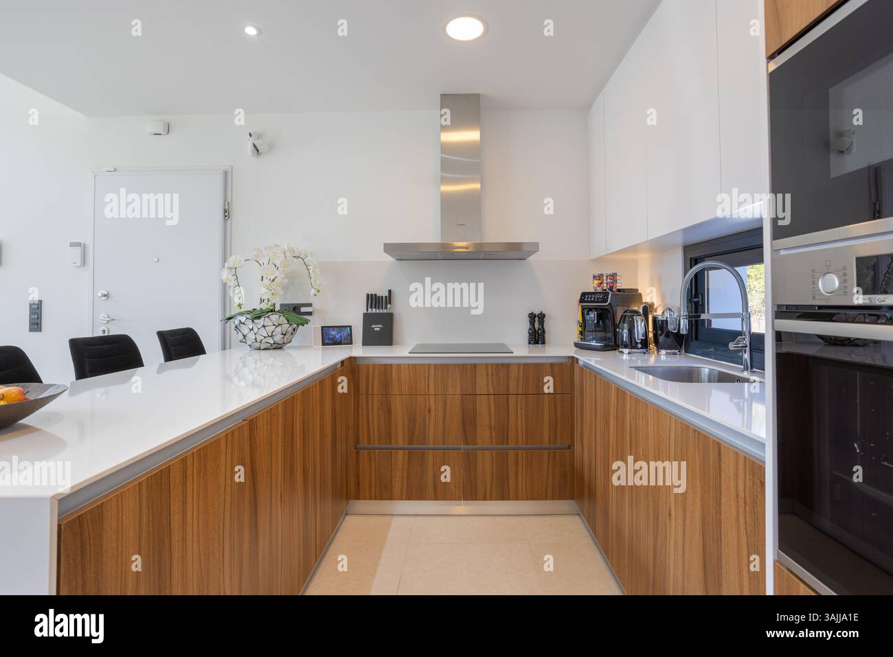 Minimalist kitchen design with integrated appliances, white counter ...