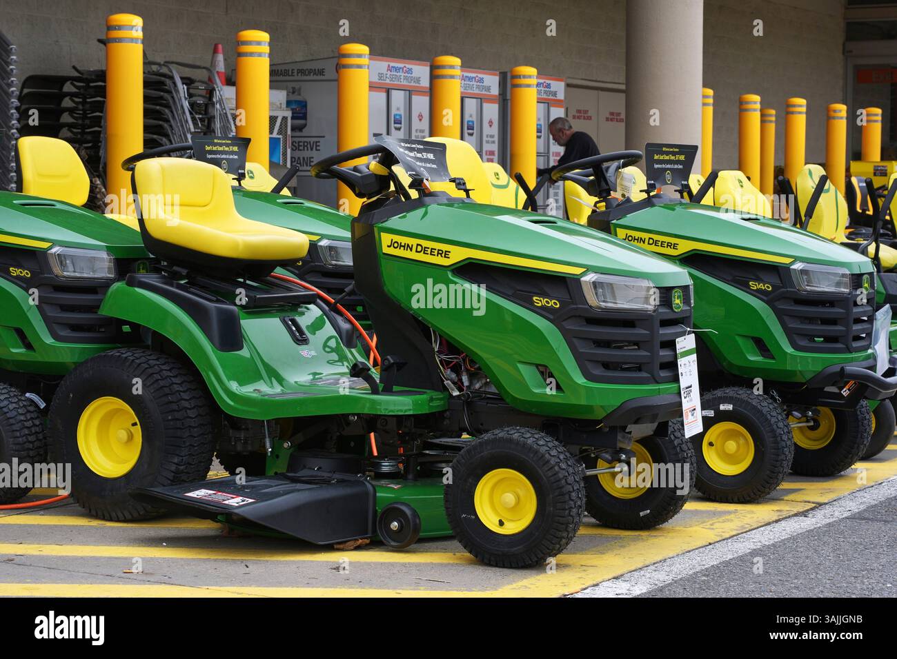 John Deere lawn tractors sit on display outside a Home Depot in ...