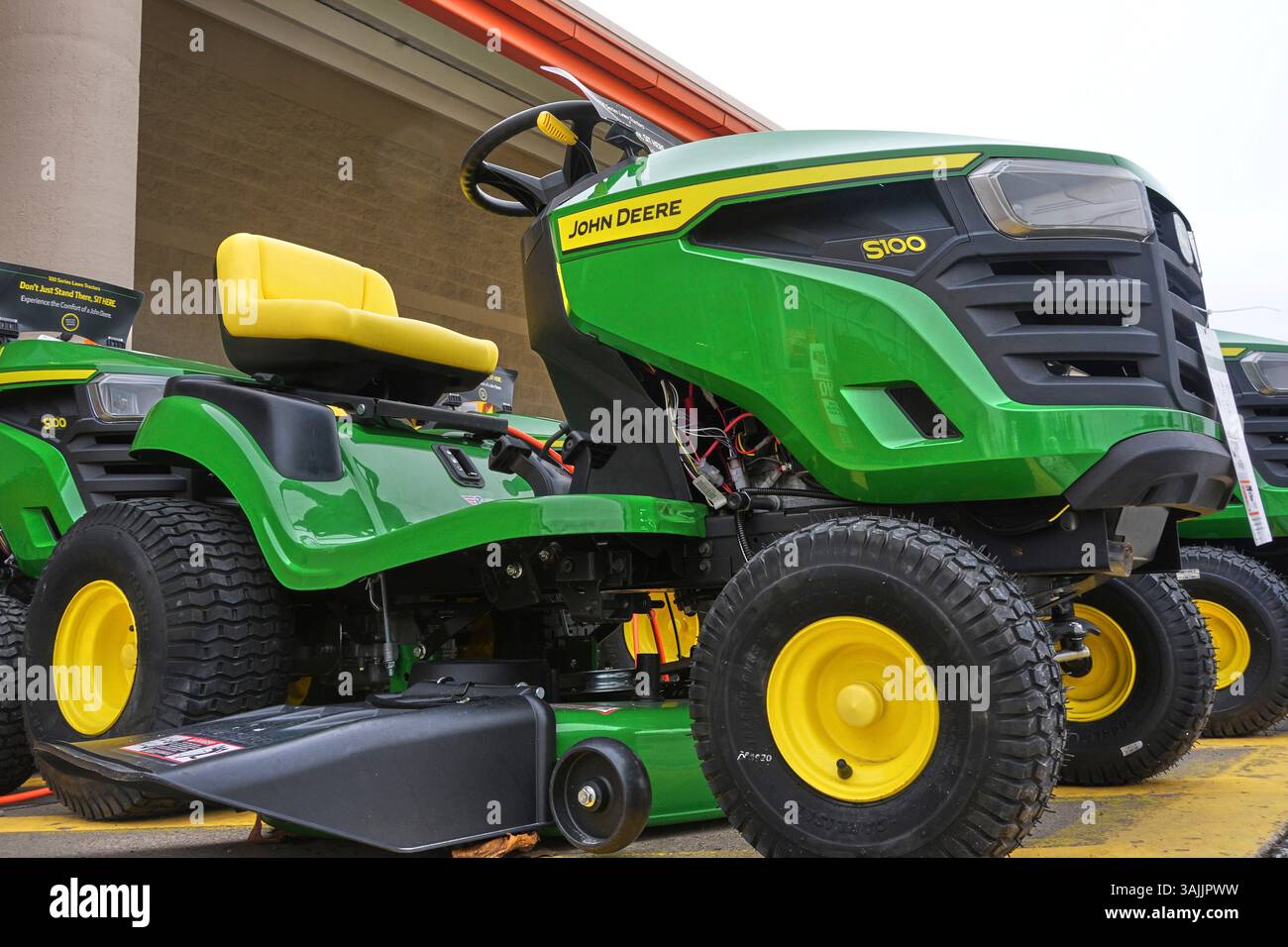 John Deere lawn tractors sit on display outside a Home Depot in ...