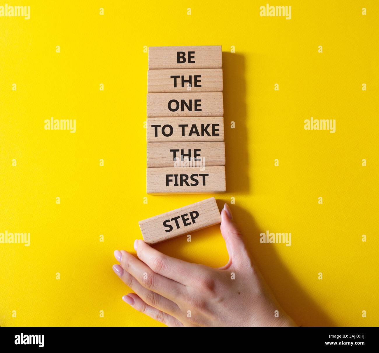 First step symbol. Wooden blocks with words Be the one to take the ...