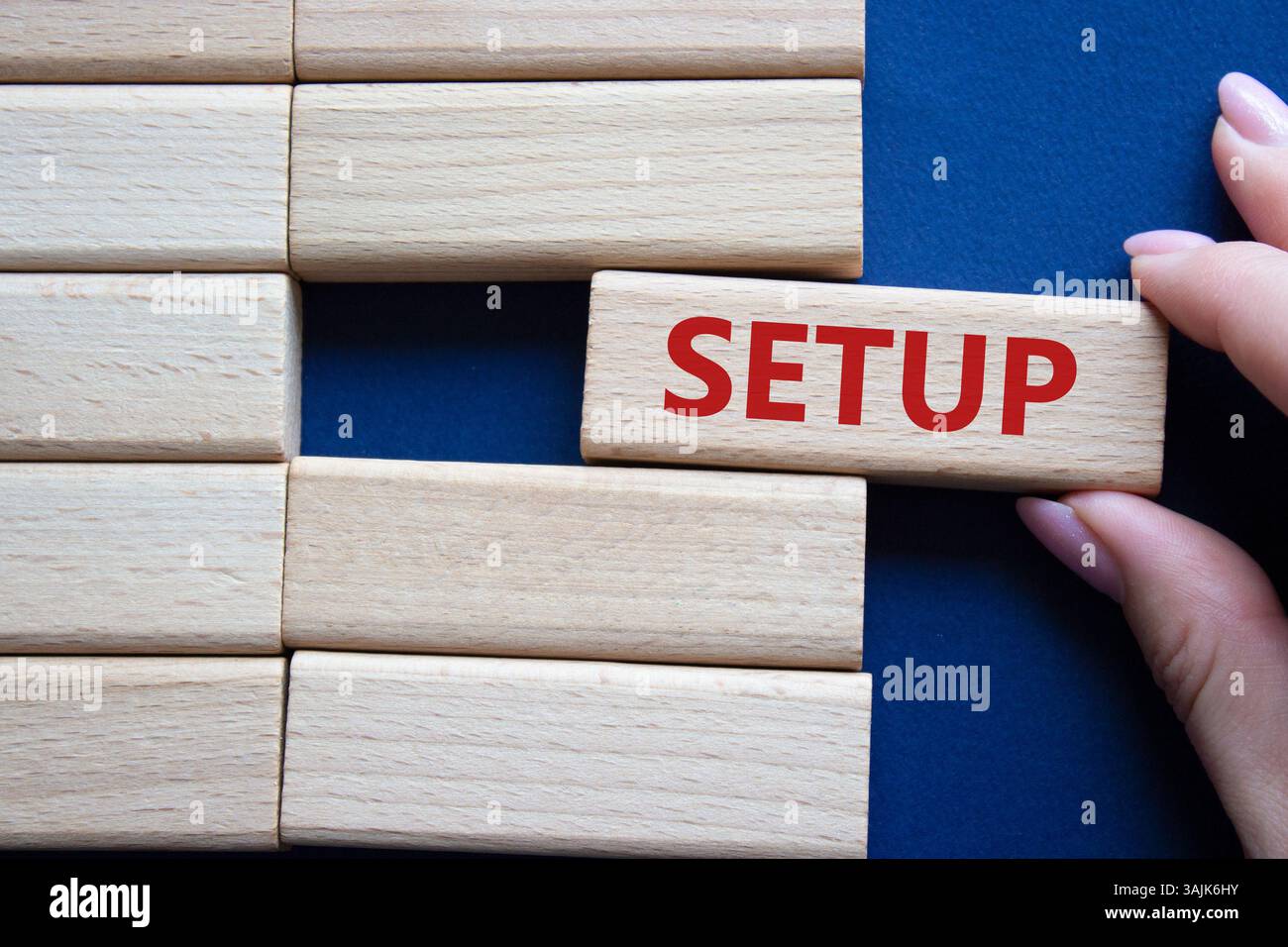 Setup symbol. Wooden blocks with word Setup. Businessman hand ...