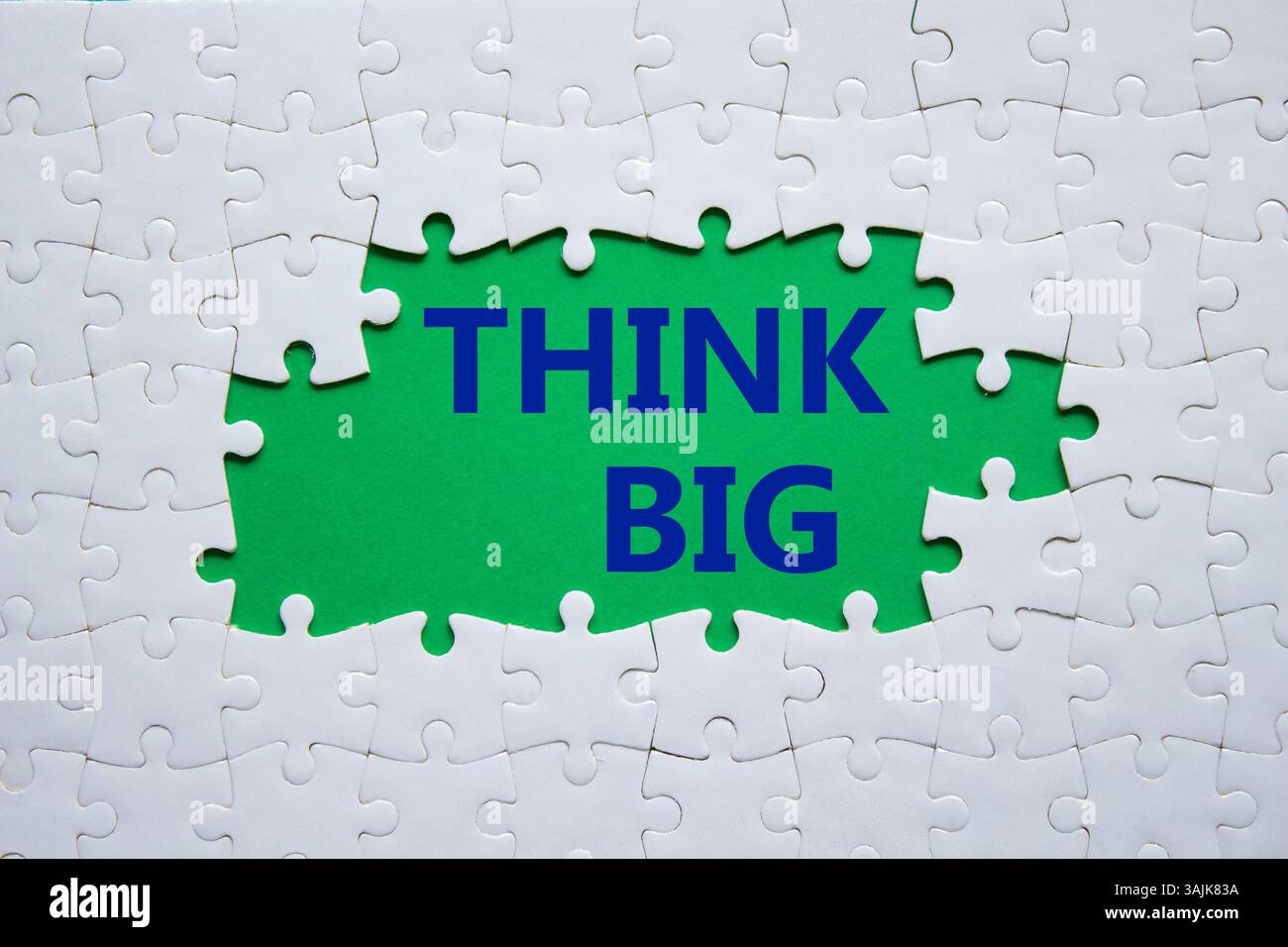 Think big symbol. White puzzle with words Think big. Beautiful green ...