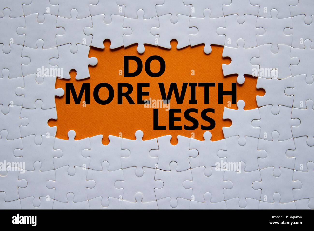 Do more with less symbol. Concept words Do more with less on white puzzle. Beautiful orange ...