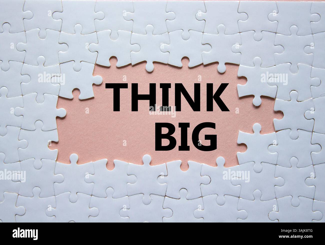 Think big symbol. White puzzle with words Think big. Beautiful pink ...