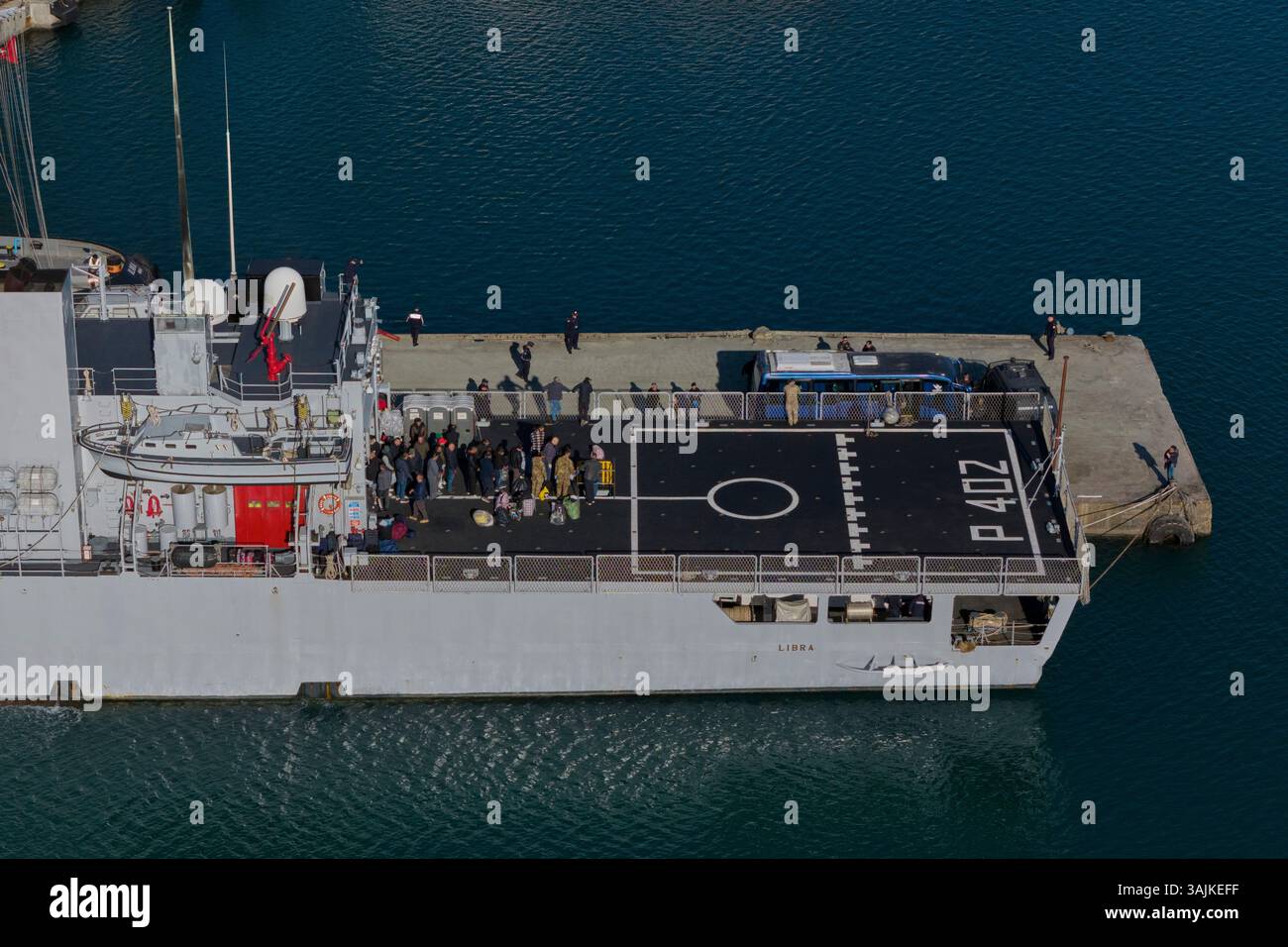 Migrants are waiting to disembarks the Italian navy ship Libra as ...