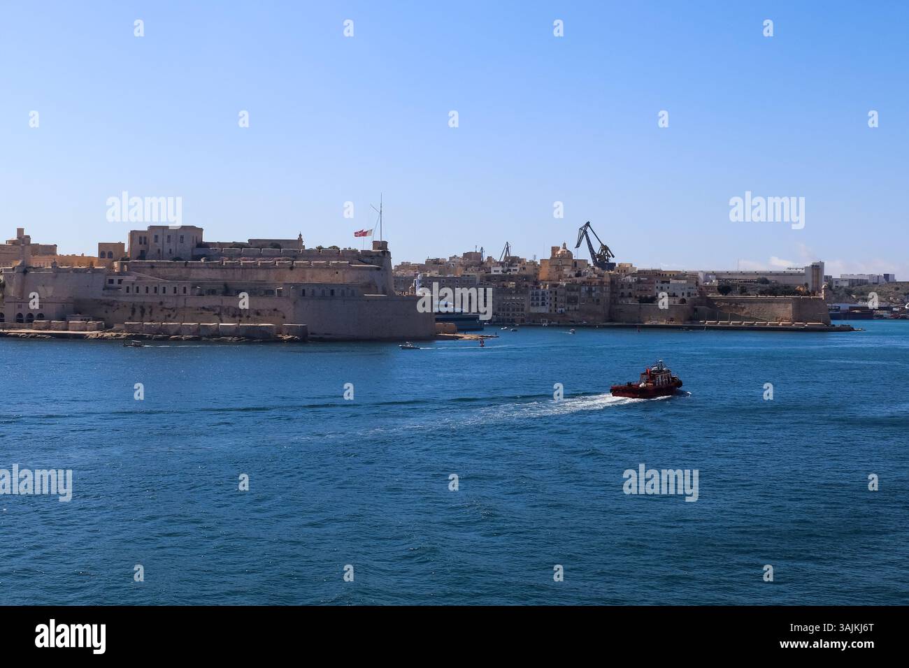 Valletta, Malta 28 September 2024: Red tugboat sailing in the Grand ...