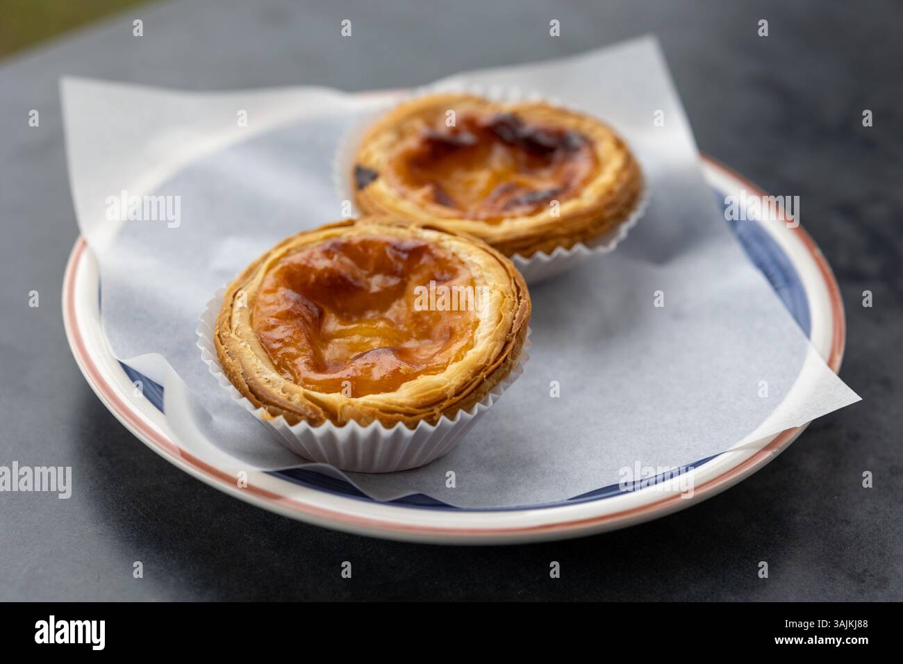 Traditional portuguese cakes pastel de nata on restaurant table Stock ...