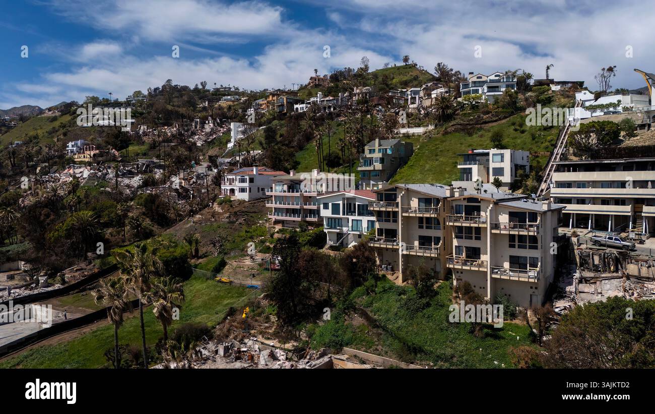 An aerial view shows the devastation in eastern Malibu, with charred landscapes and smoke rising ...