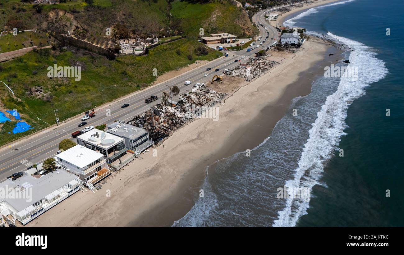 An aerial view shows the devastation in eastern Malibu, with charred landscapes and smoke rising ...
