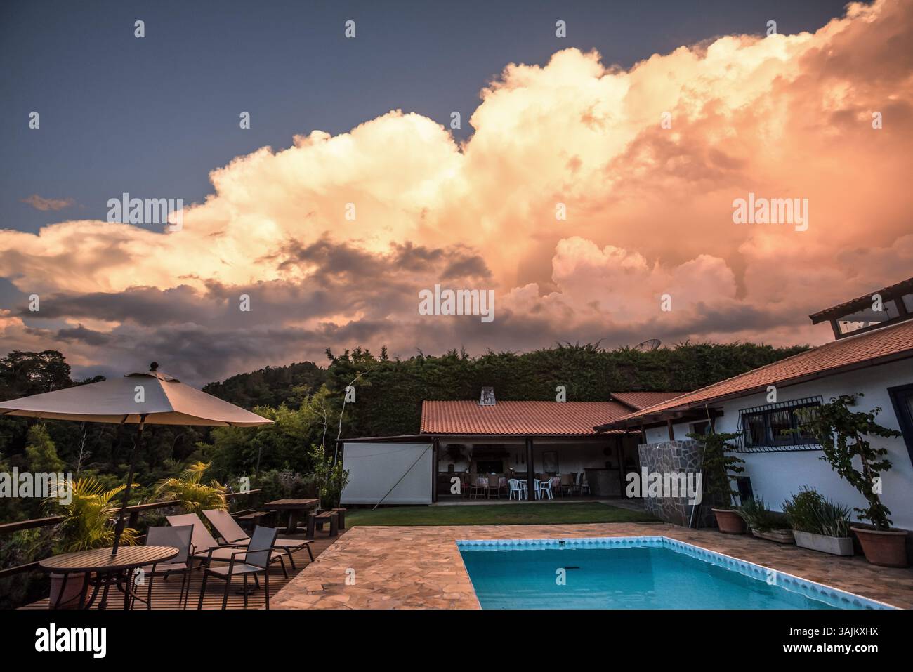 Cozy Backyard and Pool Under Golden Clouds in Itaipava, Brazil Stock Photo - Alamy