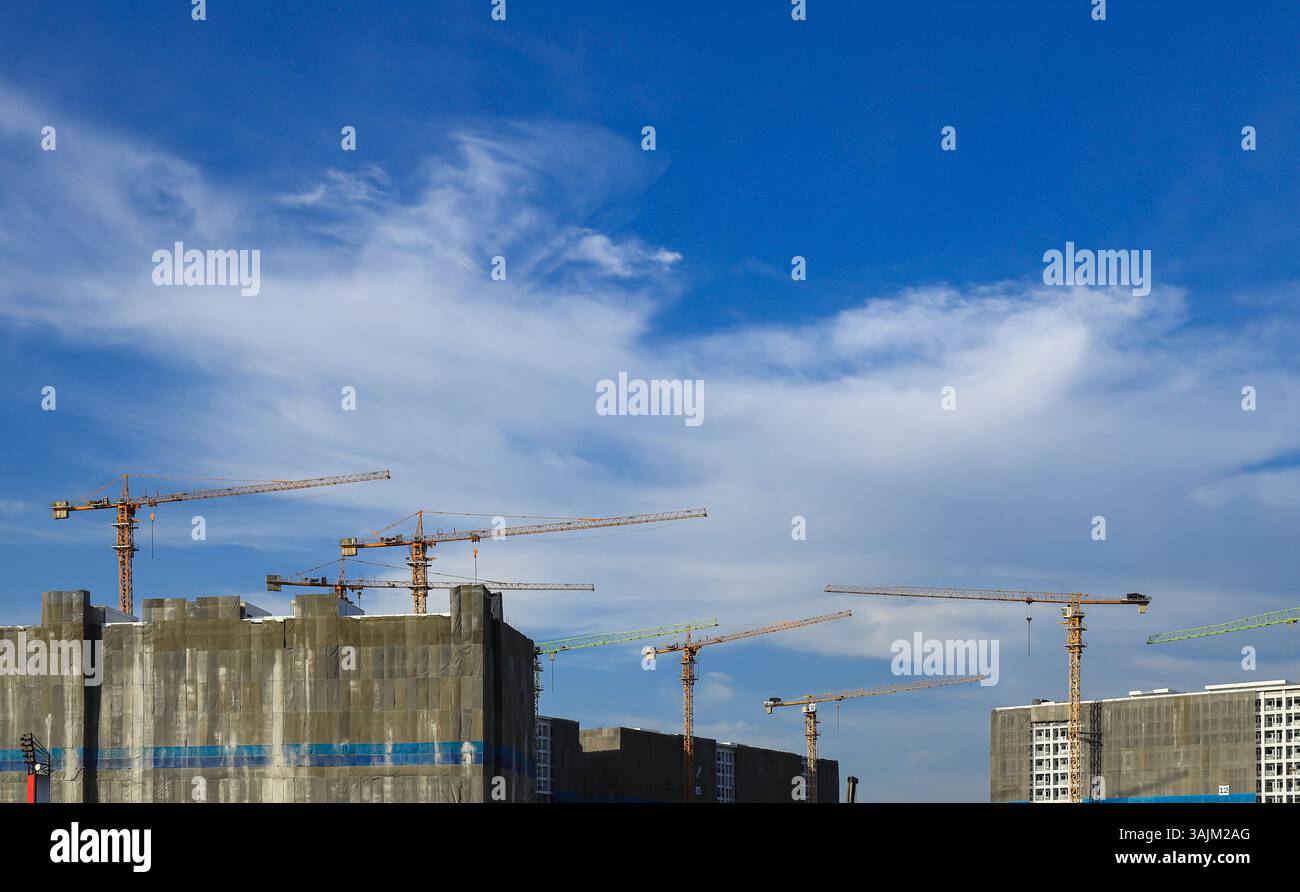 construction tower crane work with construction worker on top of ...
