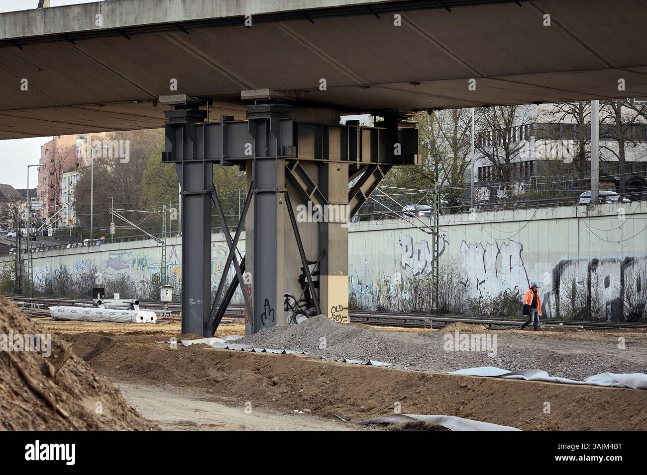 Berlin, Germany. 11th Apr, 2025. A man walks along the tracks while ...