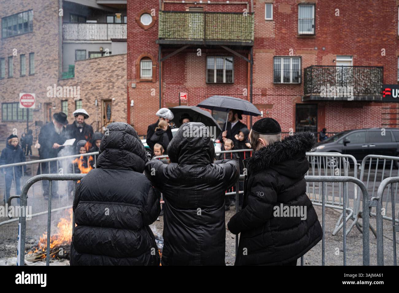 Members of the Jewish community participate in the burning of the bread ...