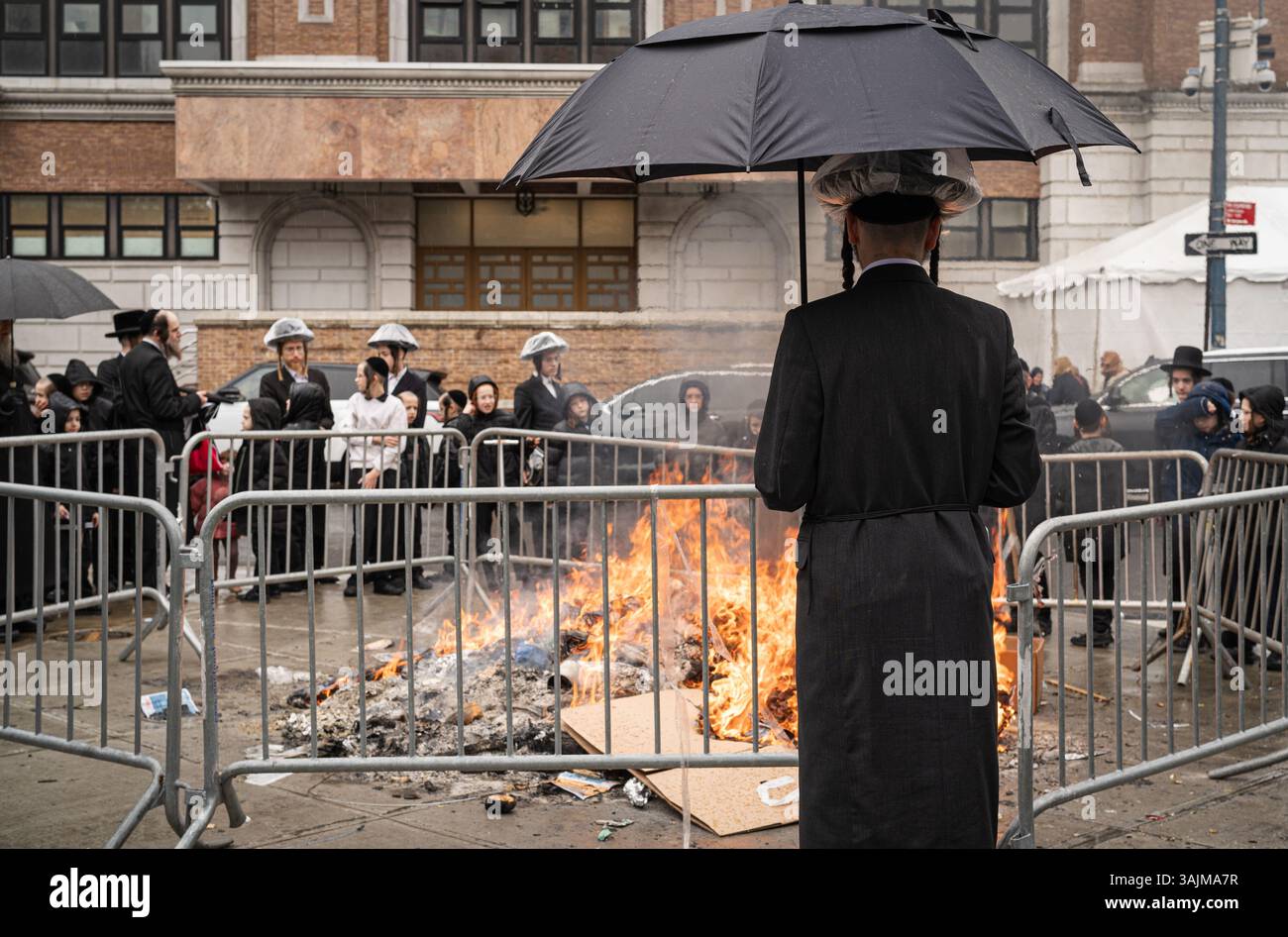 Members of the Jewish community participate in the burning of the bread ...