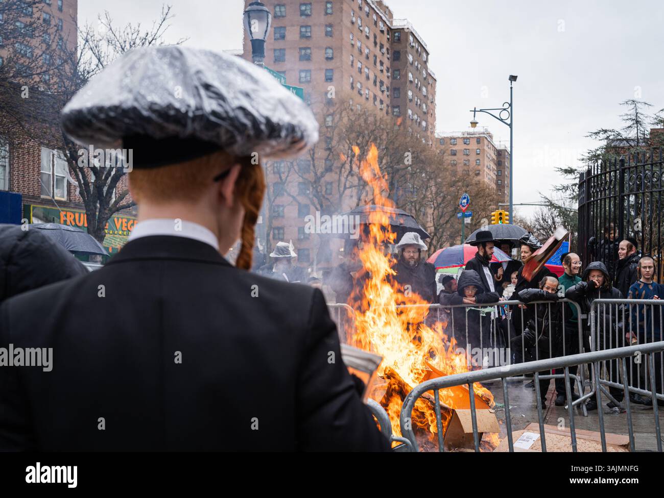 Members of the Jewish community participate in the burning of the bread ...