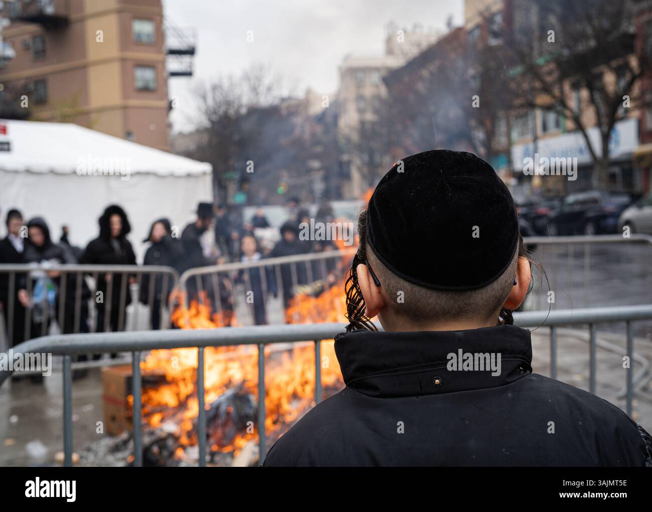 Members of the Jewish community participate in the burning of the bread ...