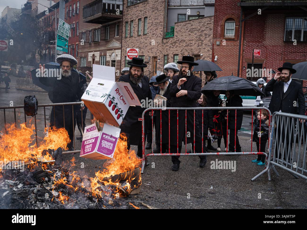 Members of the Jewish community participate in the burning of the bread ...
