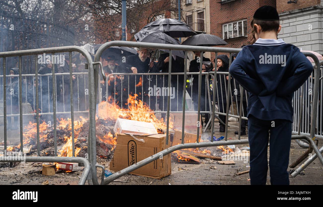 Members of the Jewish community participate in the burning of the bread ...