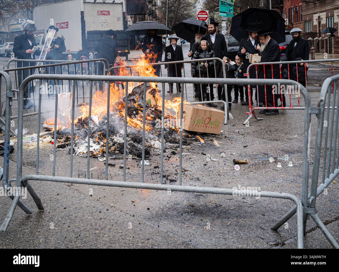 Members of the Jewish community participate in the burning of the bread ...