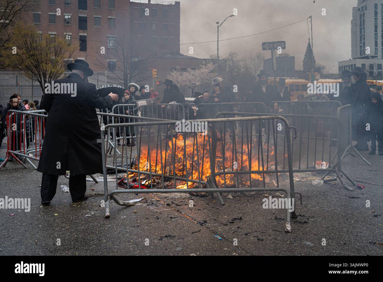 Members of the Jewish community participate in the burning of the bread ...