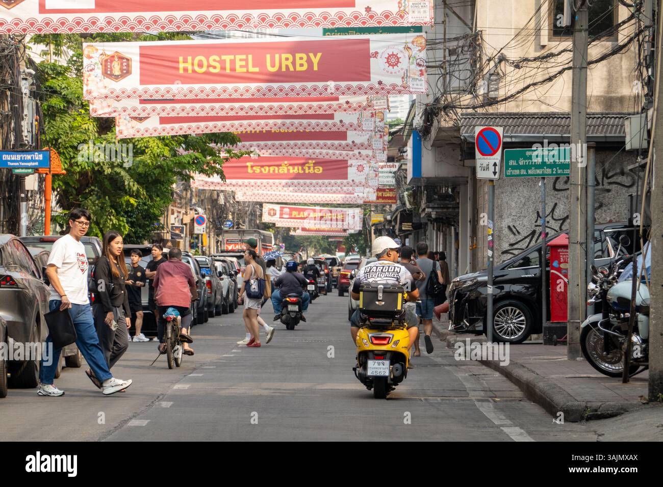 Motorcycles, locals and tourists on the streets of Bangkok, Thailand ...