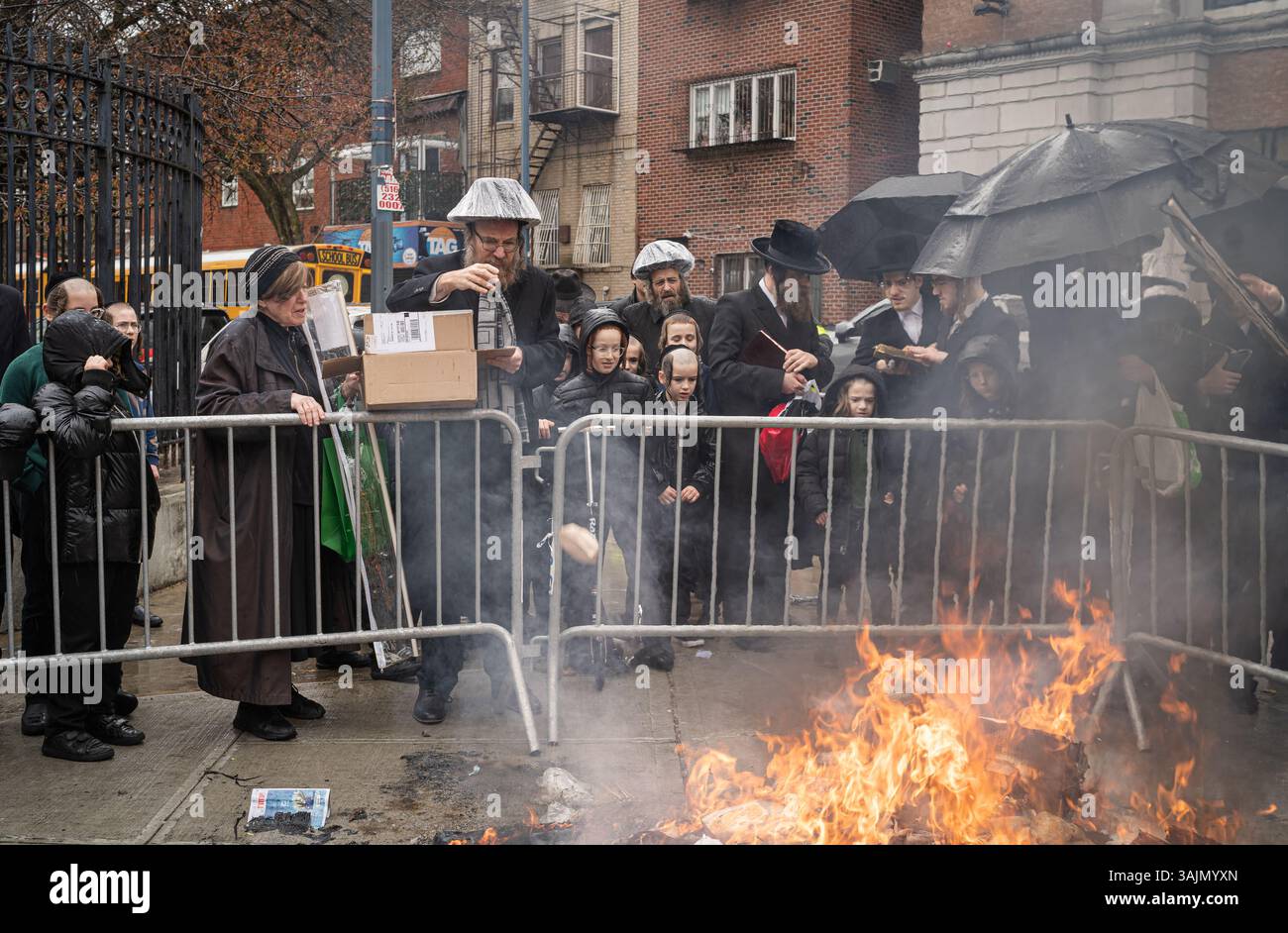 Members of the Jewish community participate in the burning of the bread ...