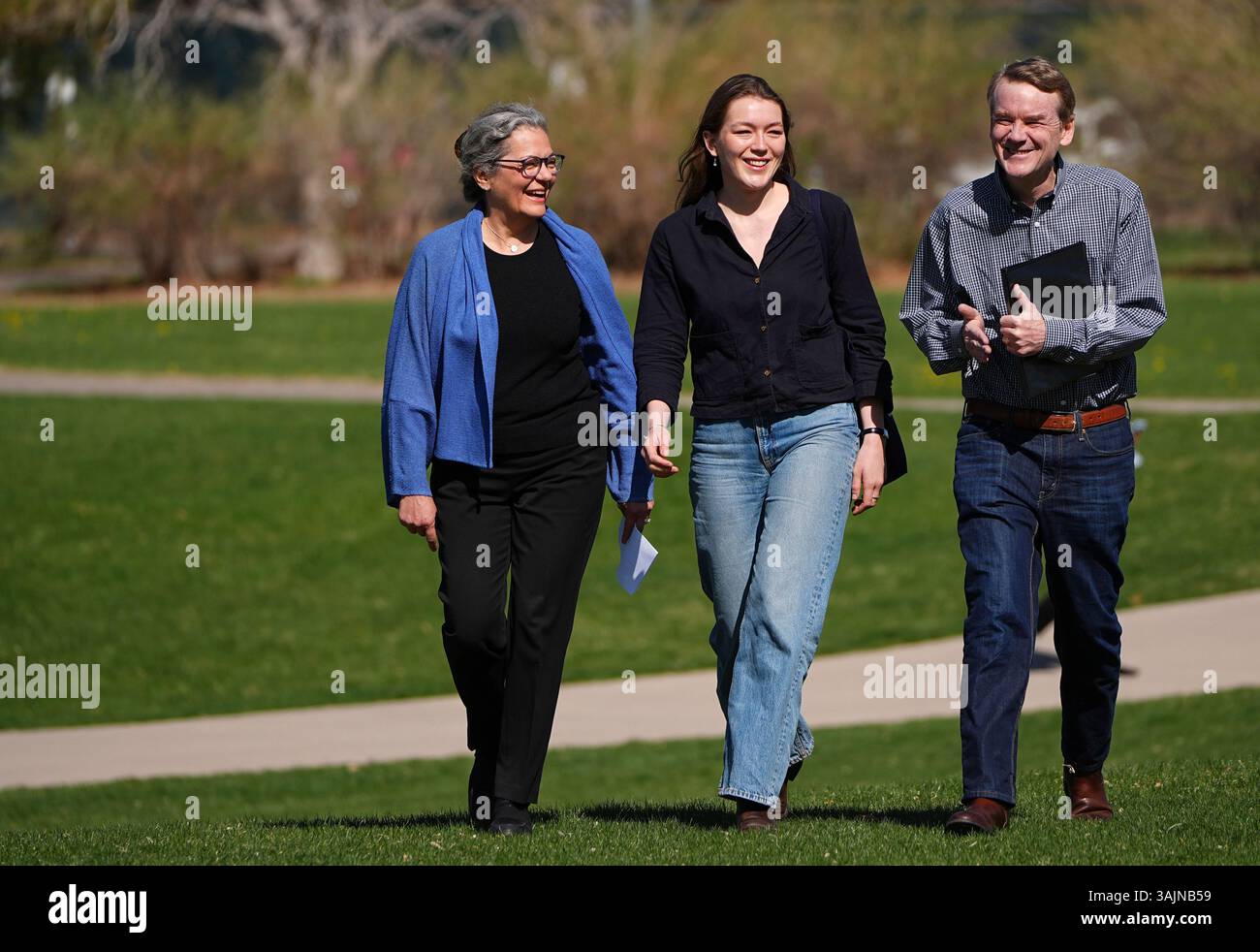 U.S. Sen. Michael Bennet, D-Colo., right, walks with his daughter ...