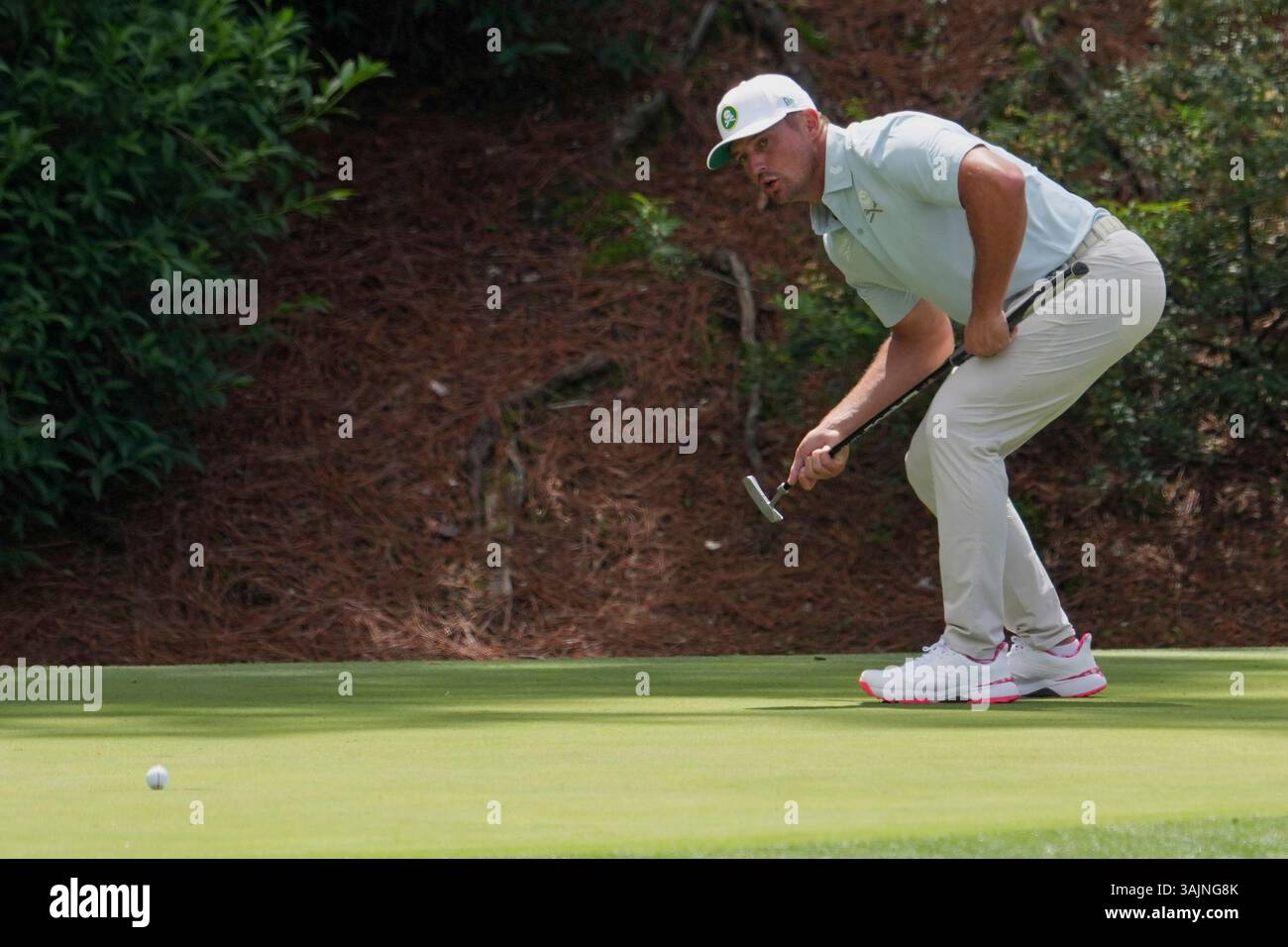 Bryson DeChambeau reacts after missing a putt on the 12th hole during ...