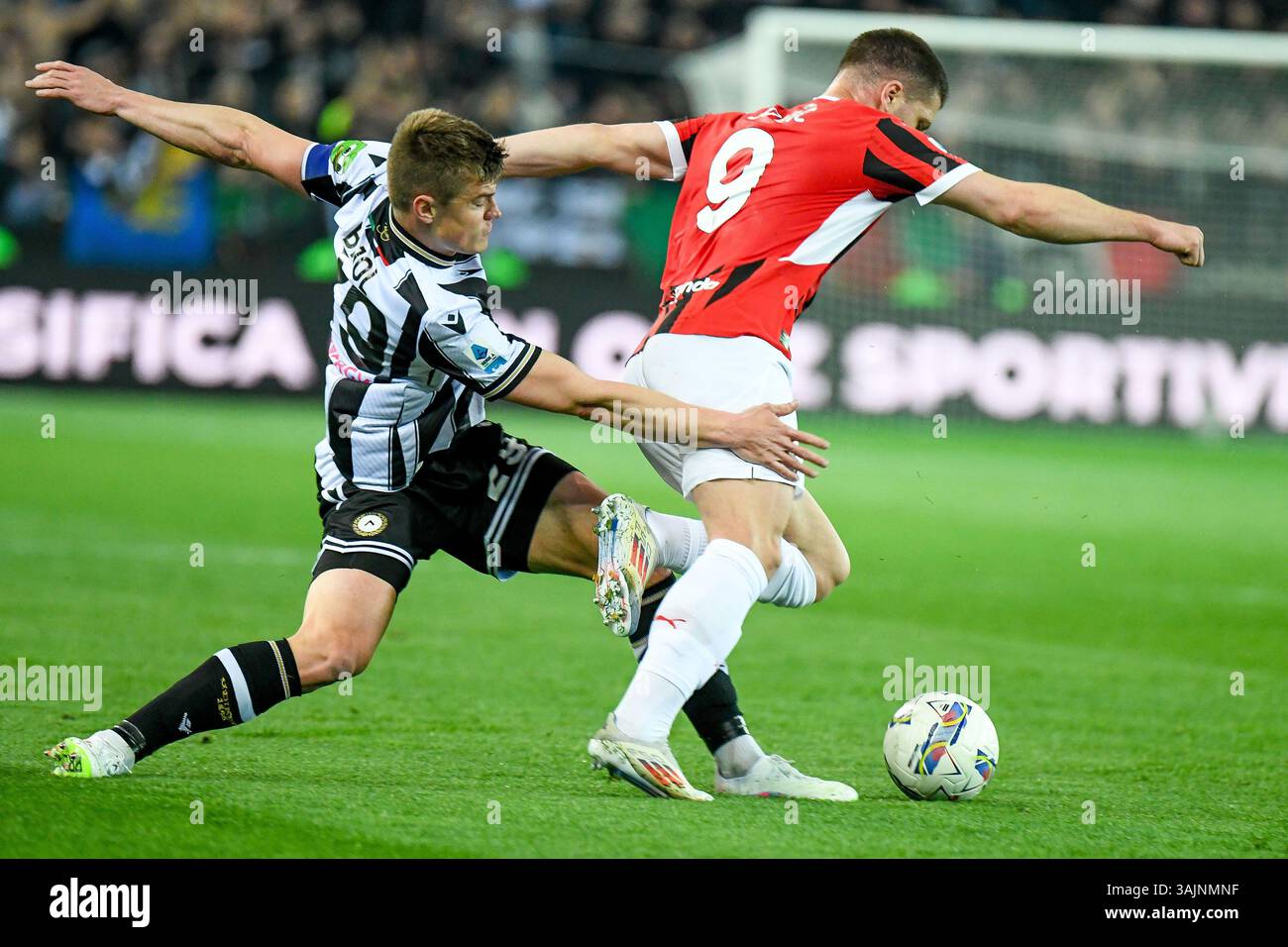 Udine, Italy. 11th Apr, 2025. Milan's Luka Jovic hindered by Udinese's ...