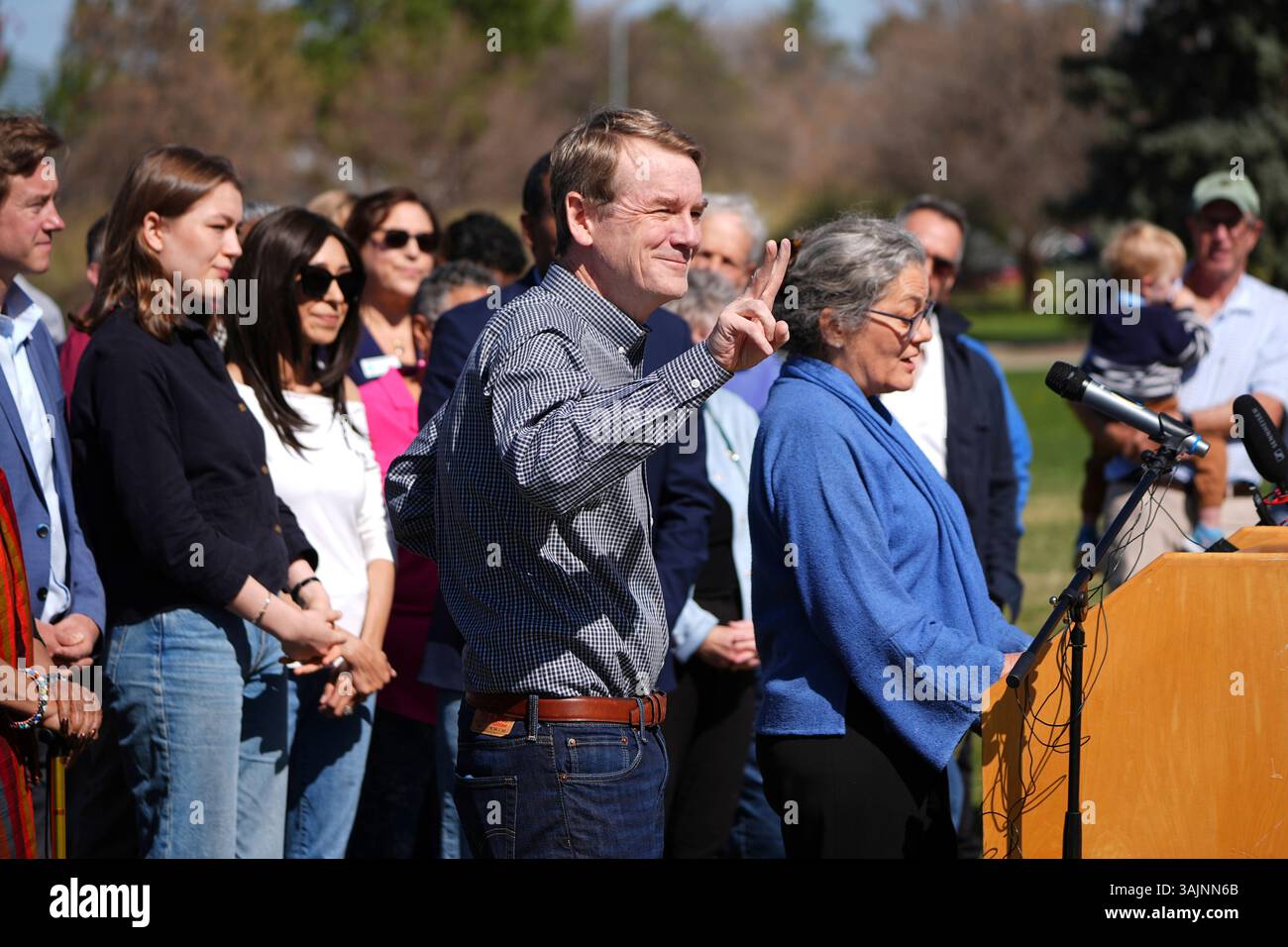 U.S. Sen. Michael Bennet, D-Colo., front, acknowledges a supporter as ...