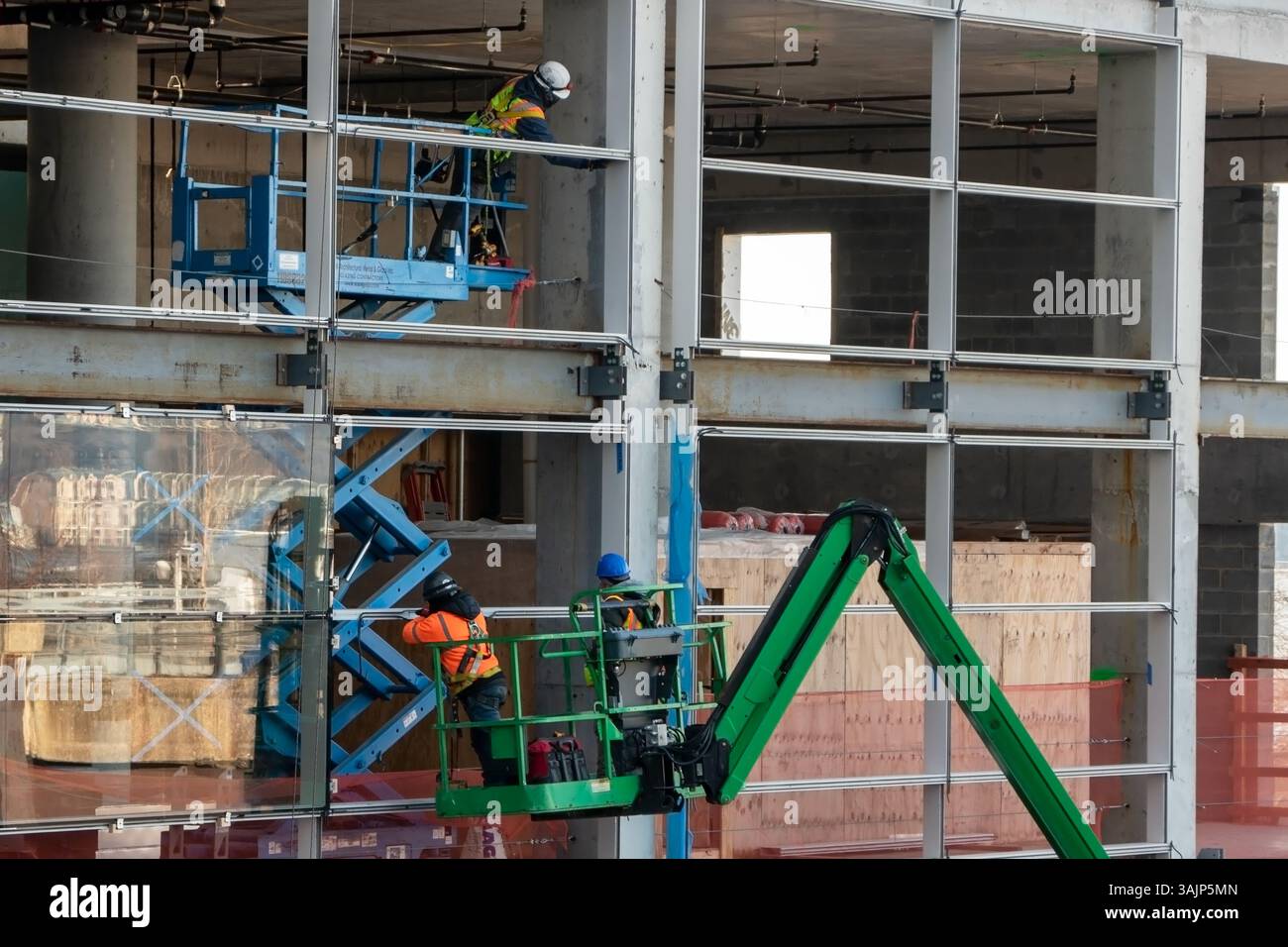 Construction workers on site building a high rise apartment complex ...