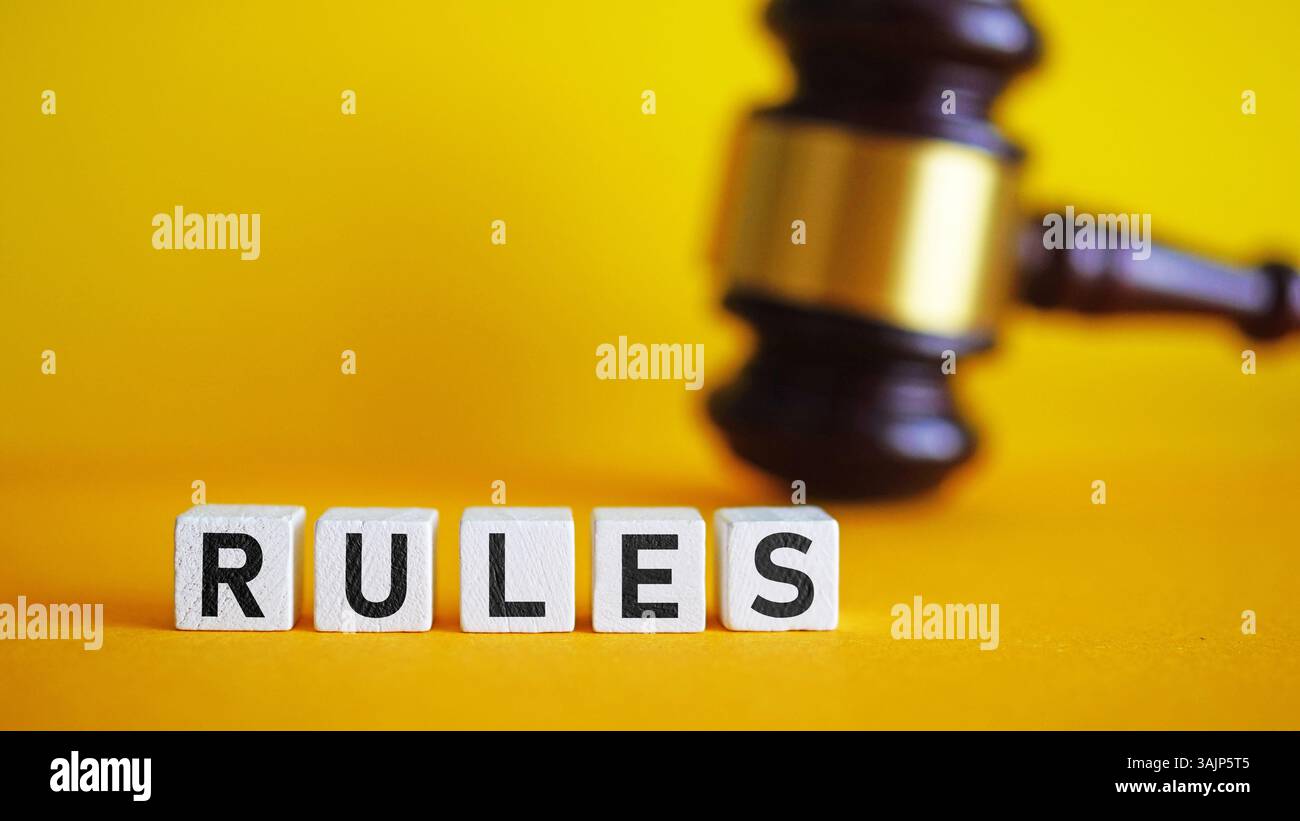 Word rules and gavel on table. Legal authority and compliance ...