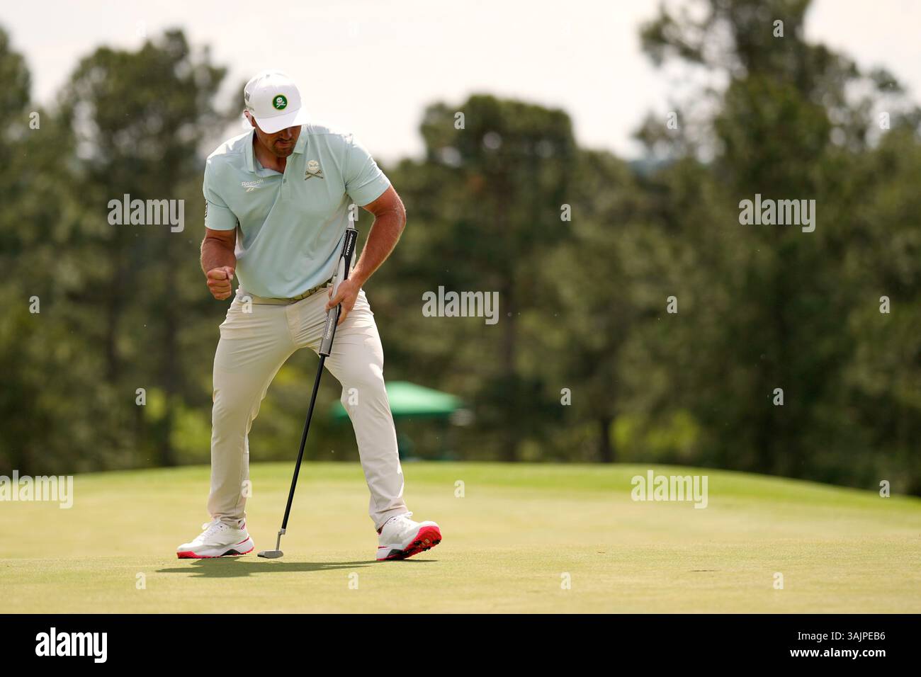 Bryson DeChambeau celebrates after making a putt on the 18th hole ...
