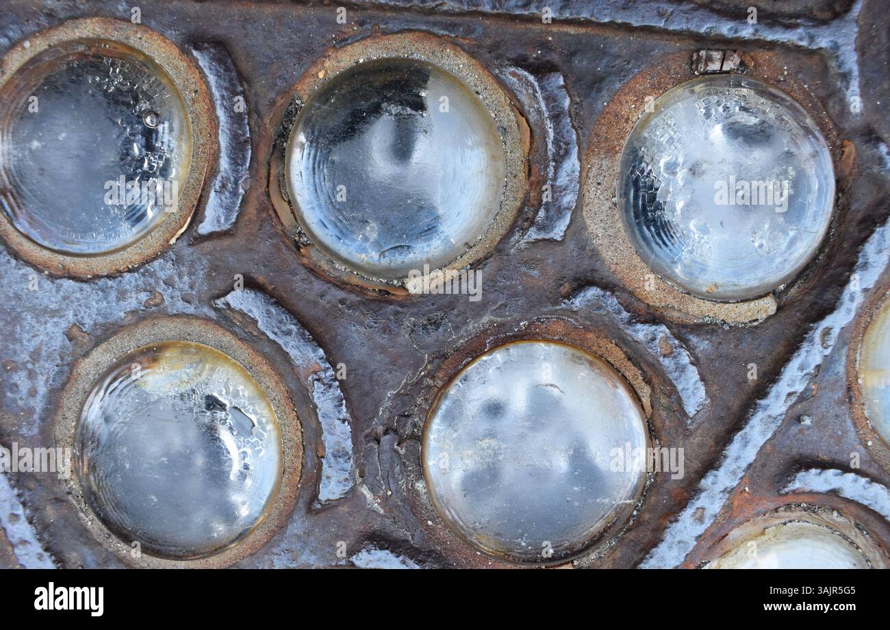 Grungy rusty metal sheet with circular glass holes and dirty surface ...