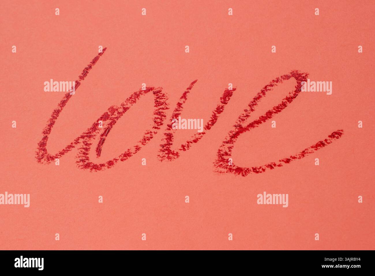 "Love" in bold red lipstick lettering on a soft pink background exudes ...