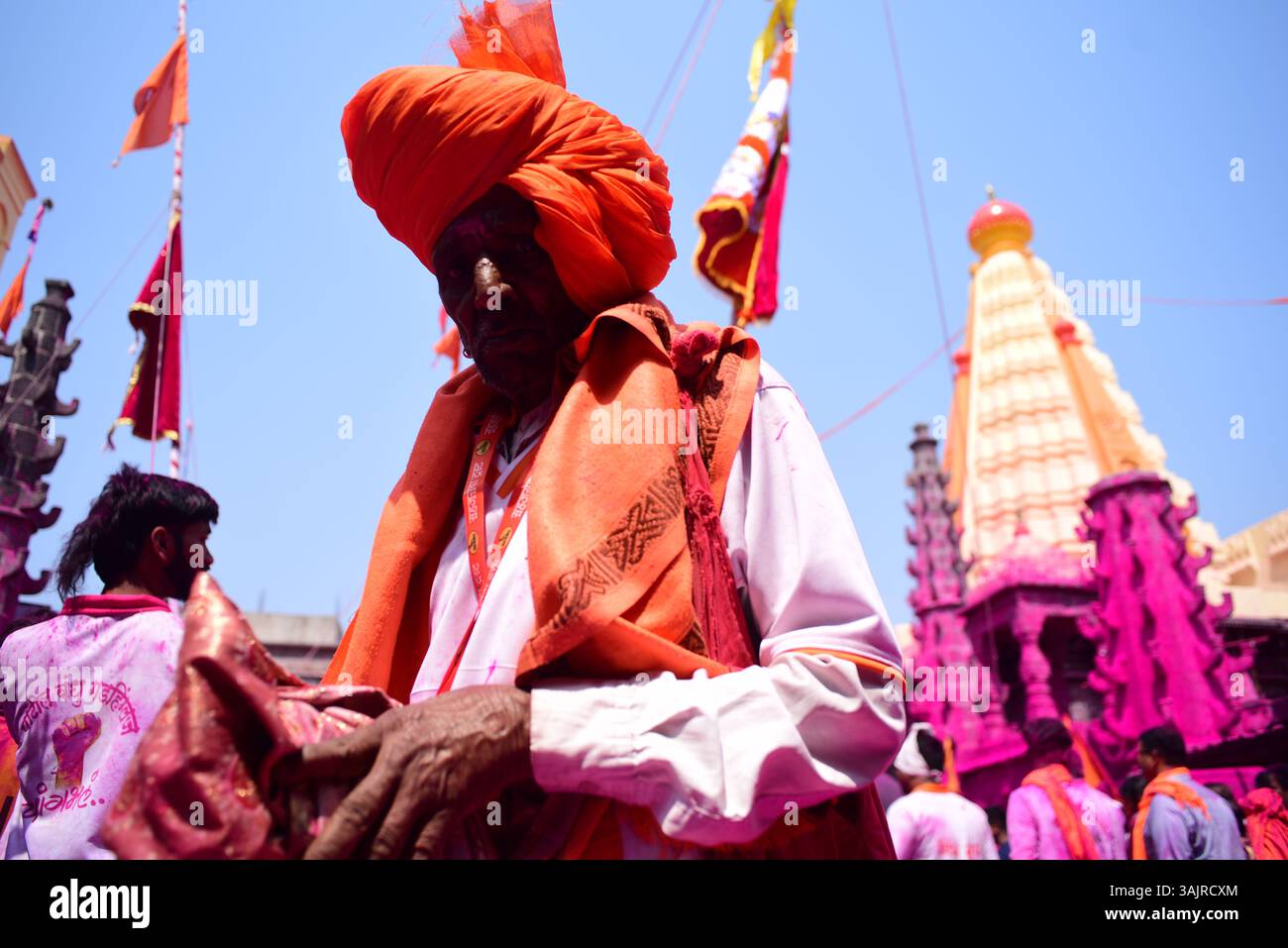 A Pilgrim with a flag in a traditional attire of Pheta and sadra and ...