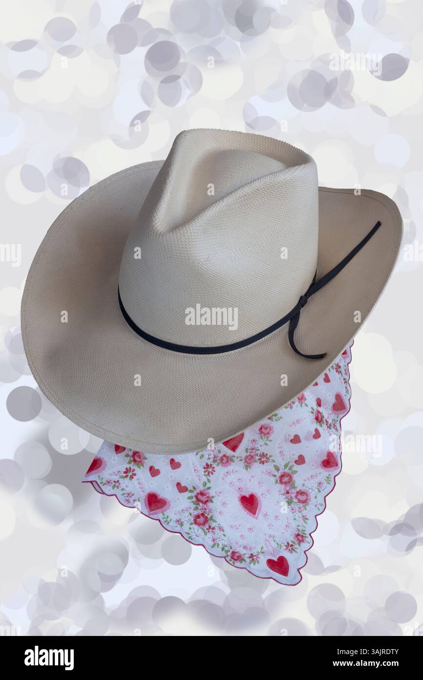 Cowboy hat hides a red heart feminine hanky handkerchief indicating ...