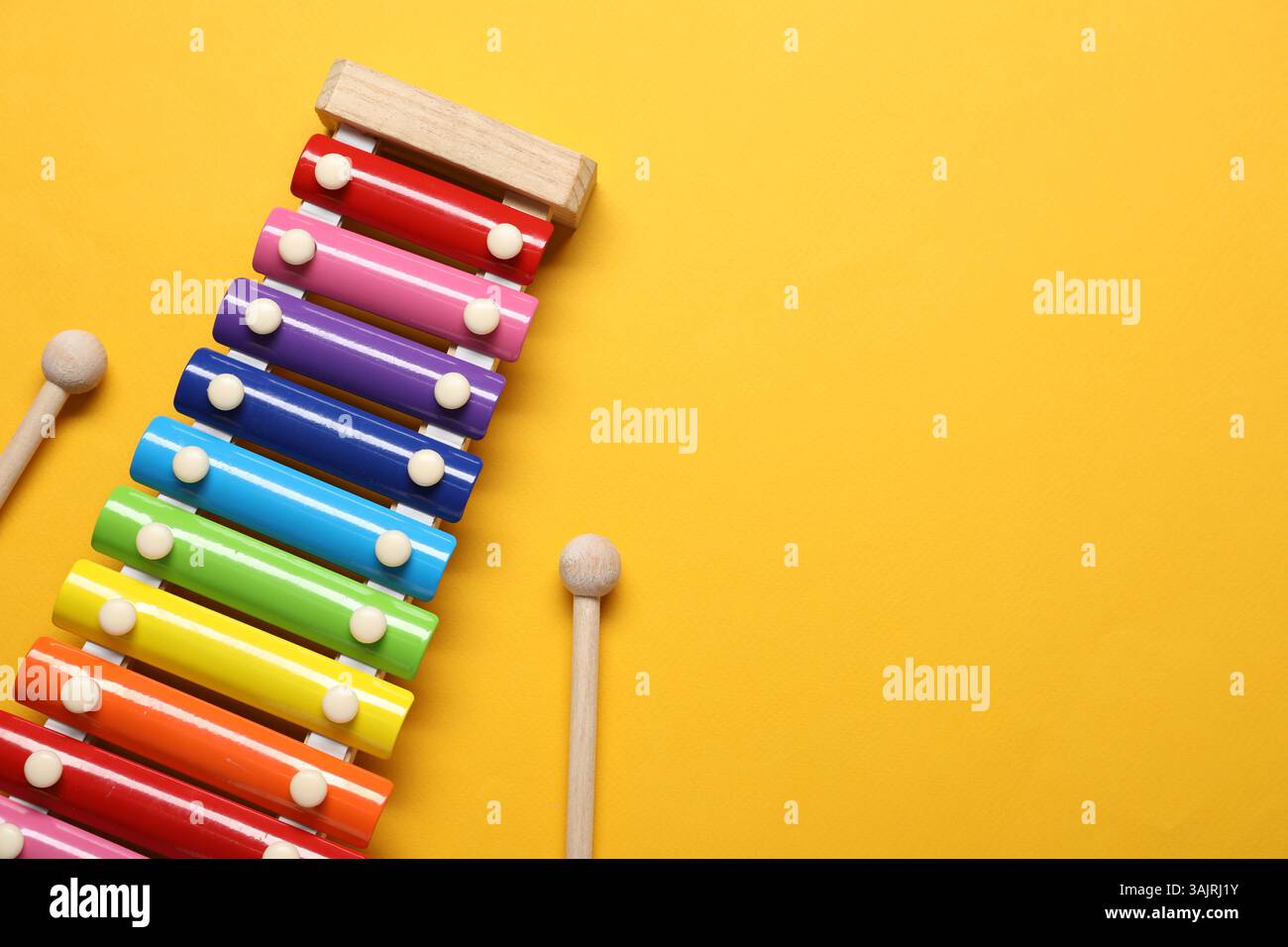 Colorful toy xylophone with mallets on yellow background, flat lay. Space for text Stock Photo ...