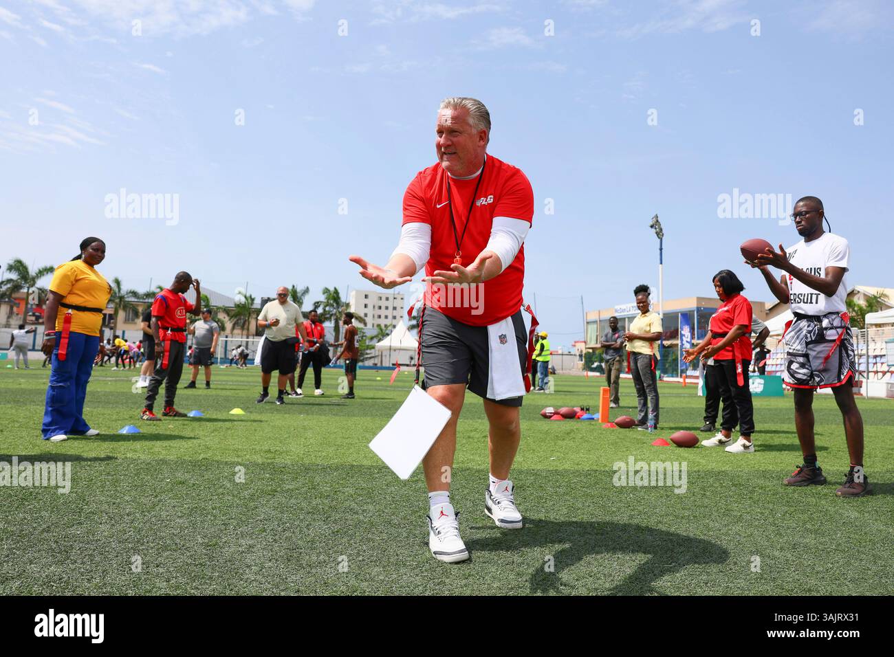 An NFL staff member demonstrates a drill during a training session for ...