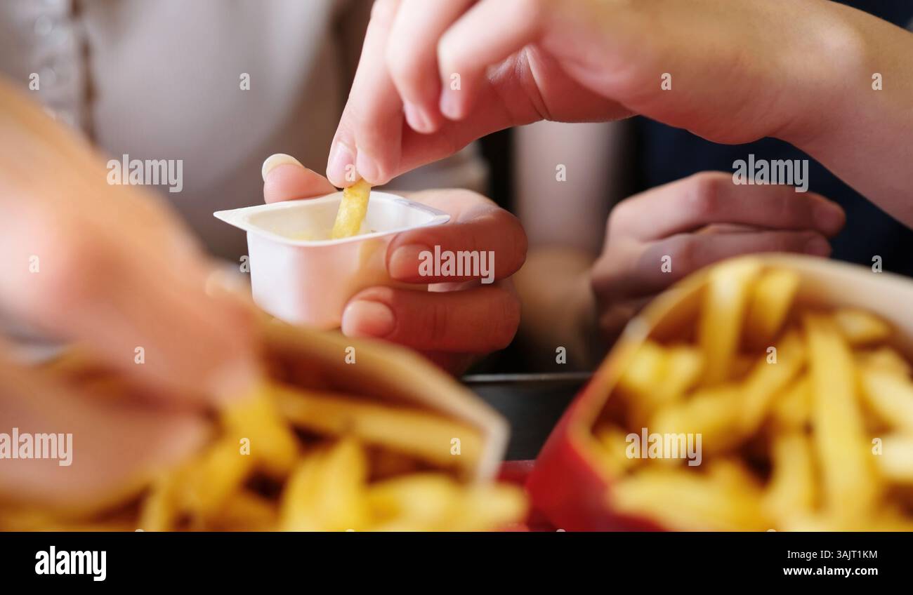 Girl consuming fast food fries hi-res stock photography and images - Alamy