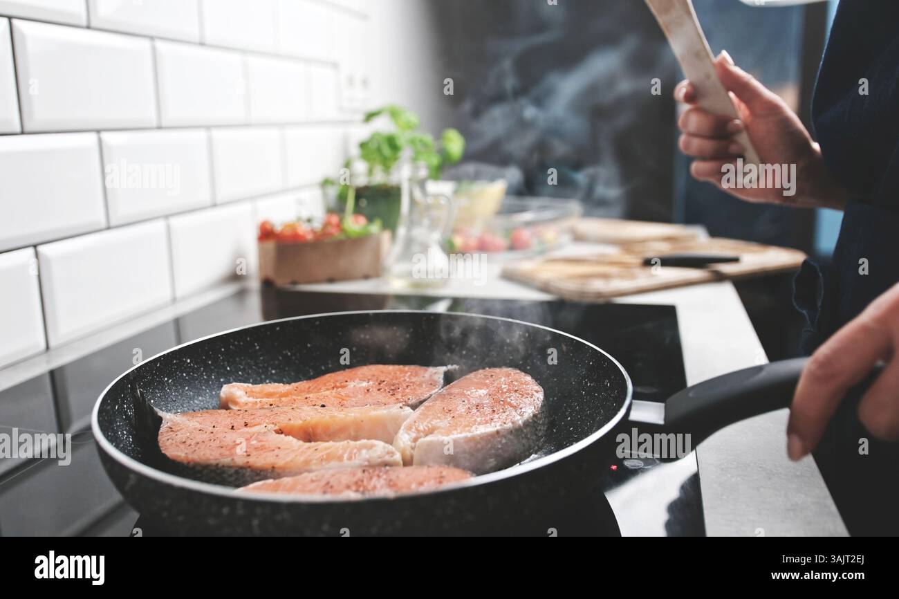 Girl frying red fish hi-res stock photography and images - Alamy