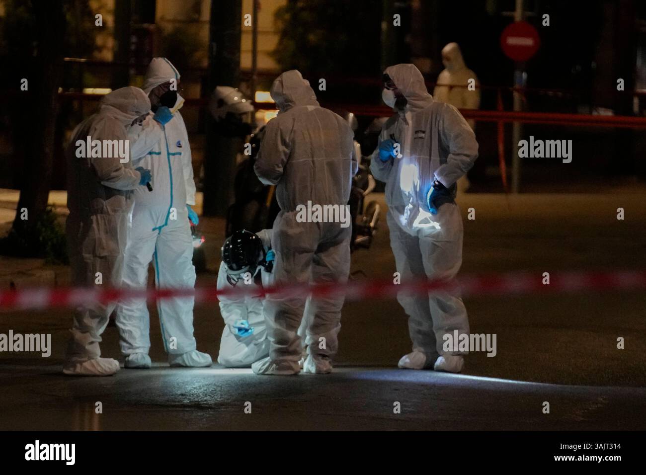 Police officers from the forensics department check the area after a ...