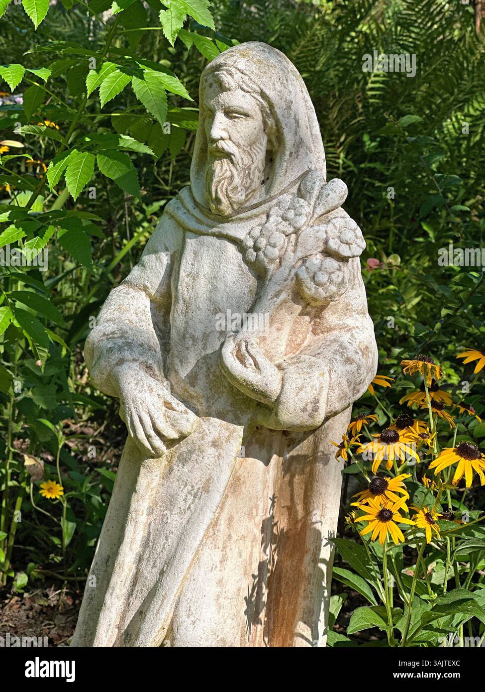 Ornamental monk in a summer garden Stock Photo - Alamy