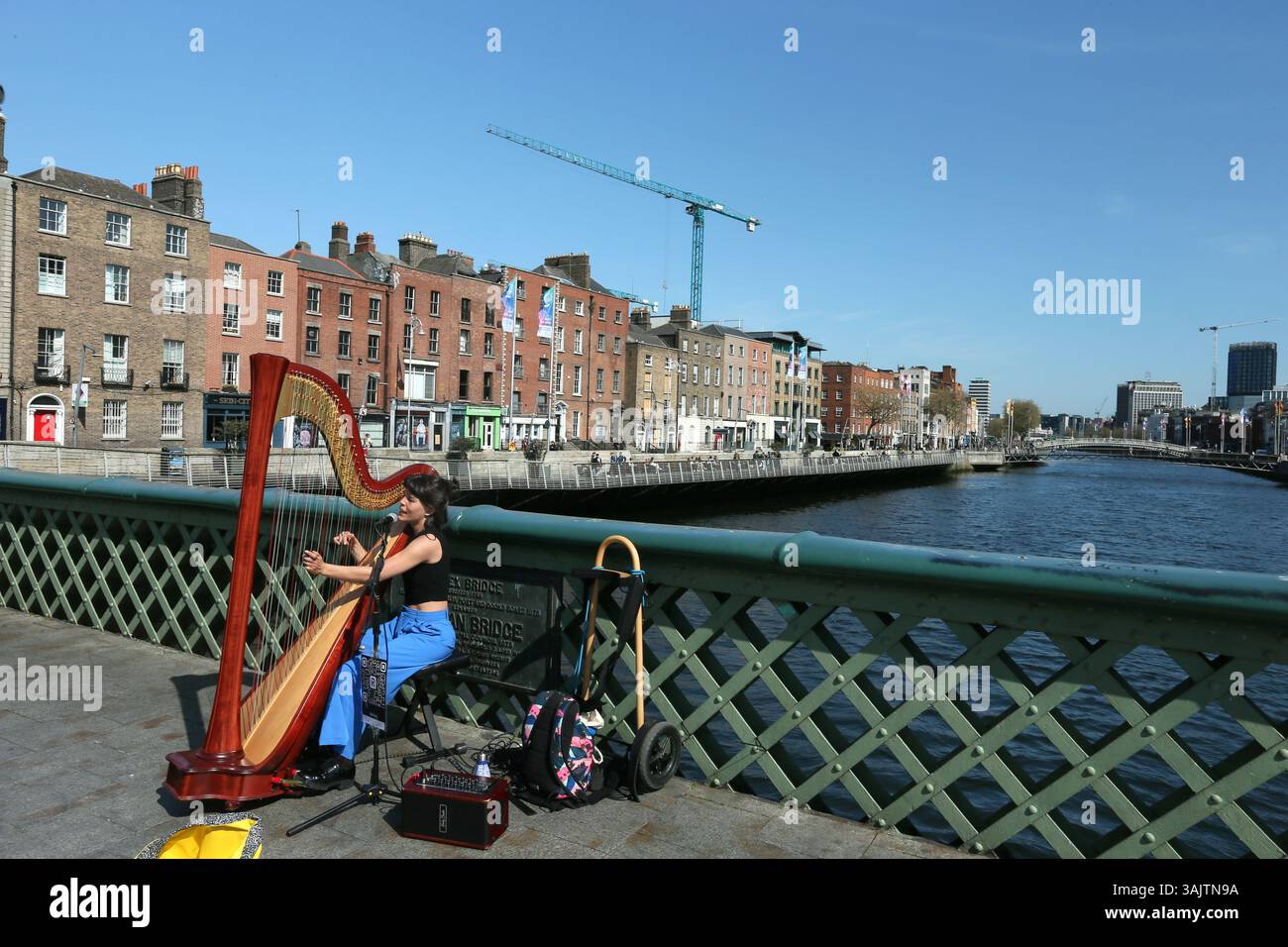 Dublin, Ireland - 11th April 2025 - A woman plays the classical harp on ...