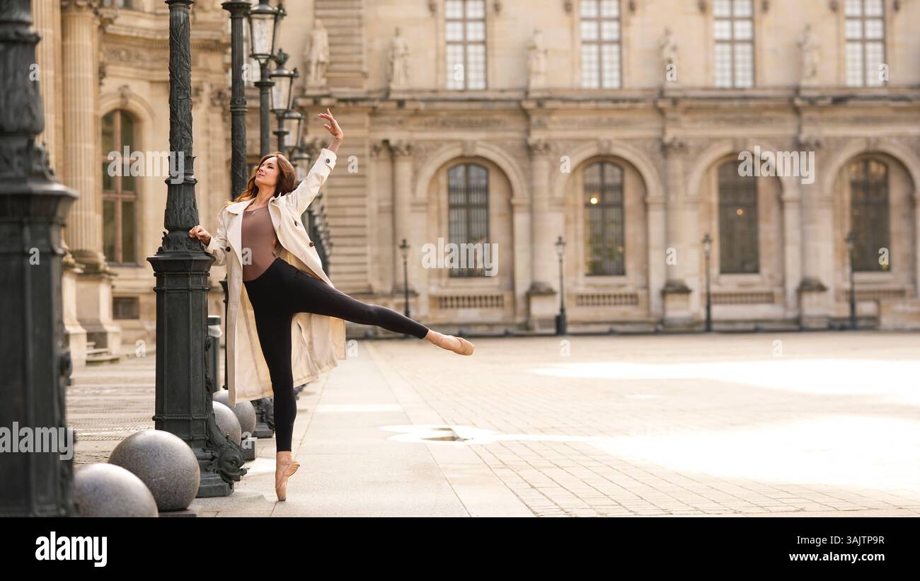 Ballet dancer performs arabesque near Louvre Museum in Paris, France ...