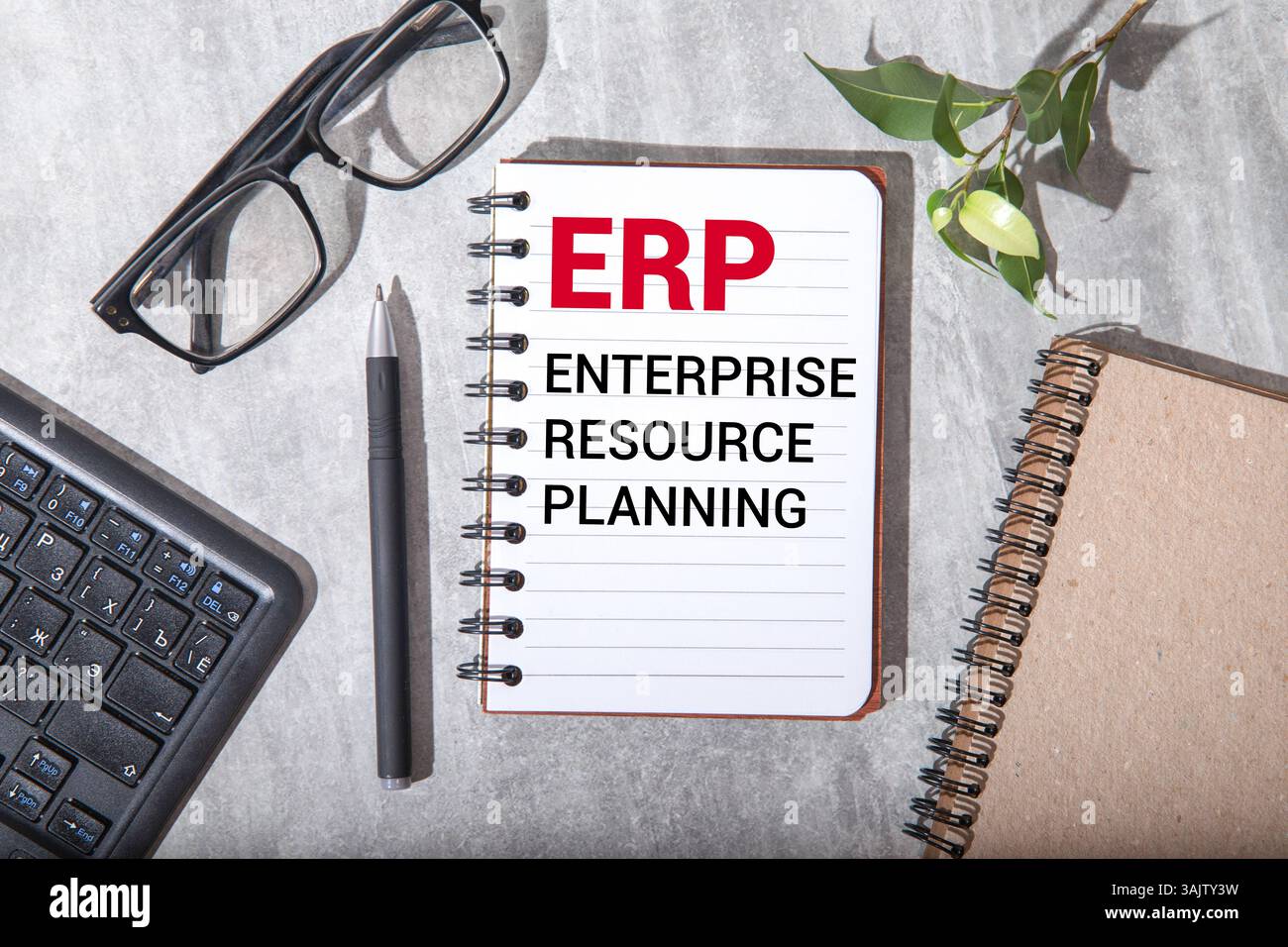 ERP (Enterprise Resource Planning) calendar and orange notepad near ...