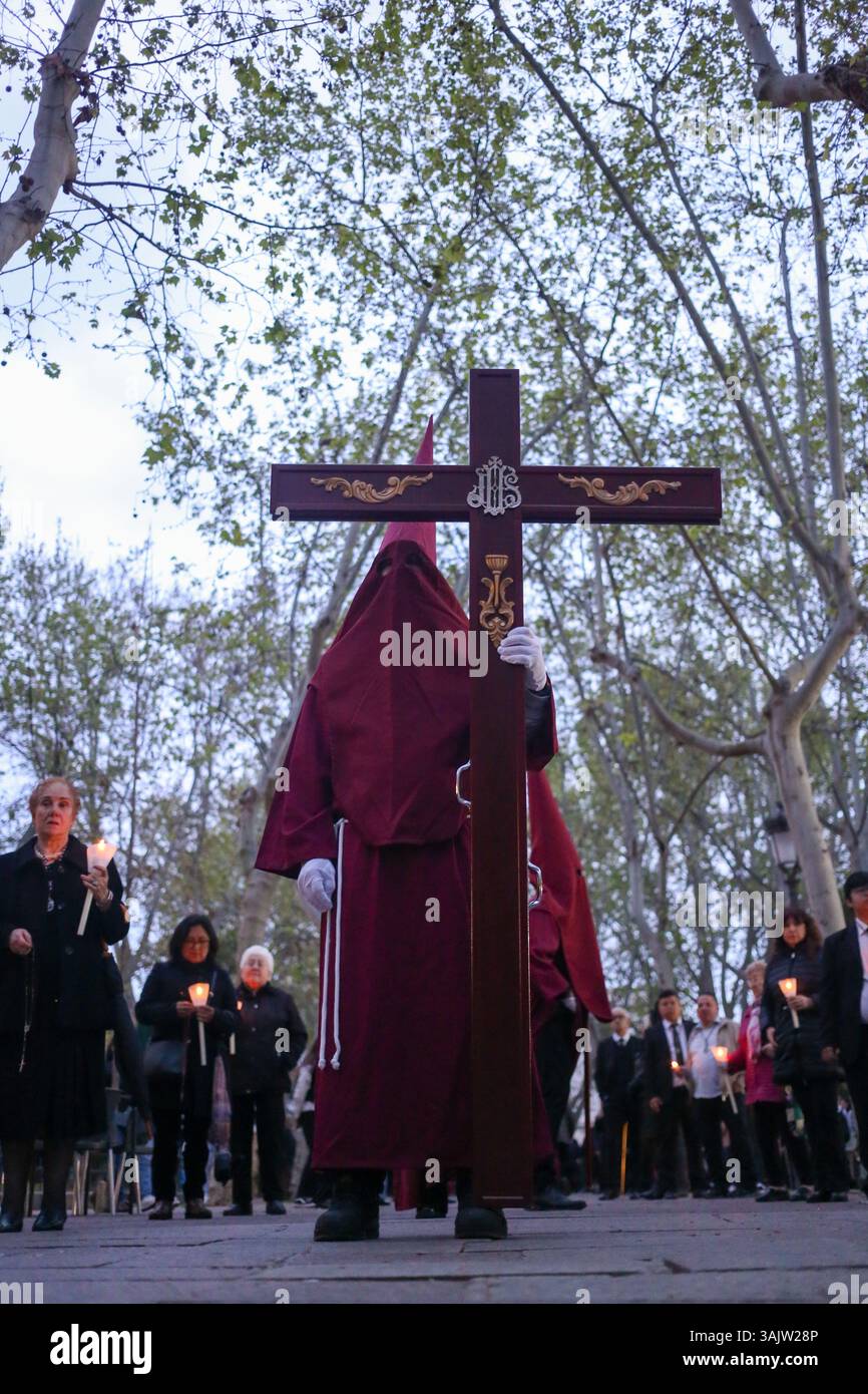 Madrid, Spain, April 11, 2025: A Nazarene carrying the cross during the ...