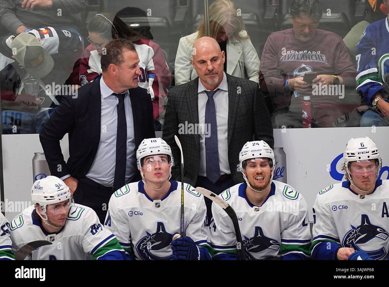 Vancouver Canucks assistant coach Adam Foote chats with head coach Rick ...